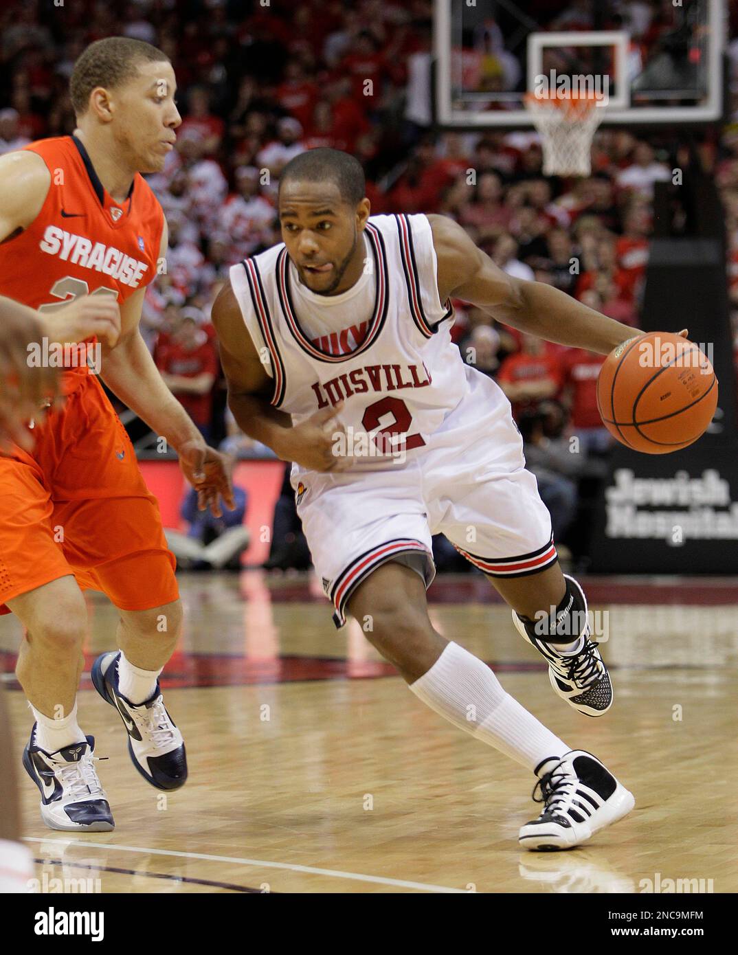 Louisville's Preston Knowles (2) drives past Syracuse's Brandon Triche ...