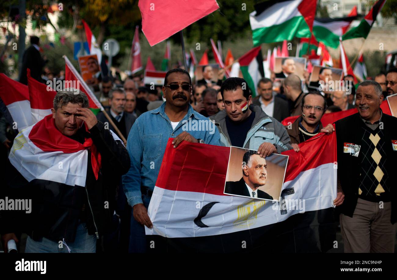 Israeli Arabs hold Egyptian and Palestinian flags as well as pictures ...