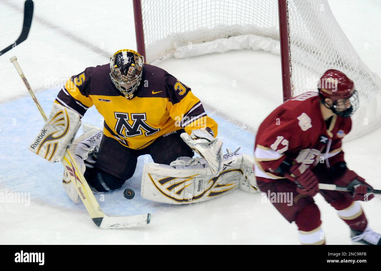 Minnesota's Kent Patterson, left, makes a save against Denver in the ...