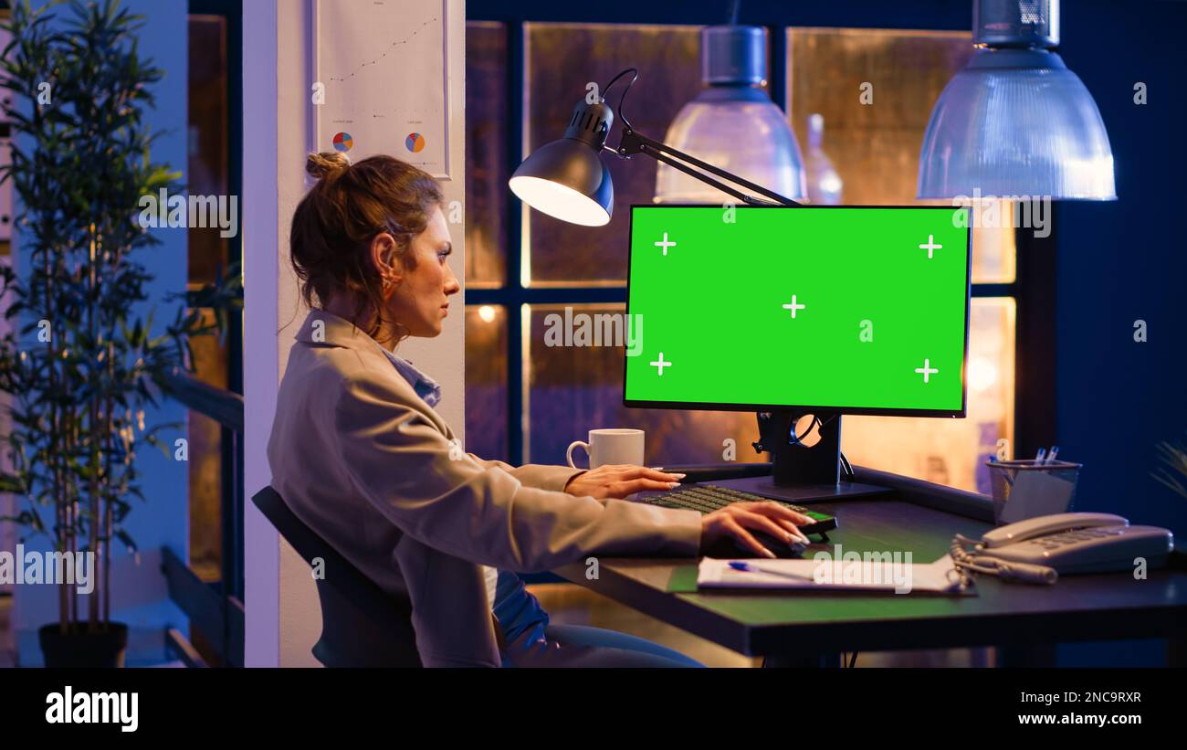 Female Advisor Working At Night With Green Screen On Computer Analyzing Isolated Display With