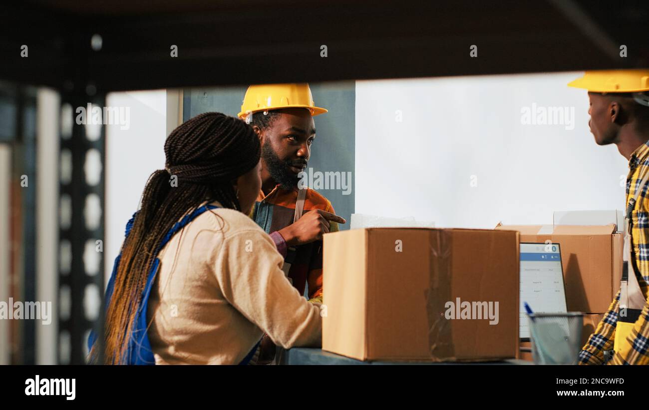 Group of employees working on logistics and packing supplies, checking ...