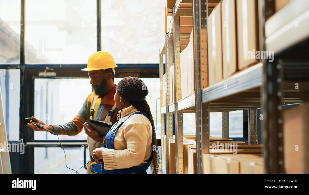 Worker and supervisor scanning products with barcodes in warehouse ...