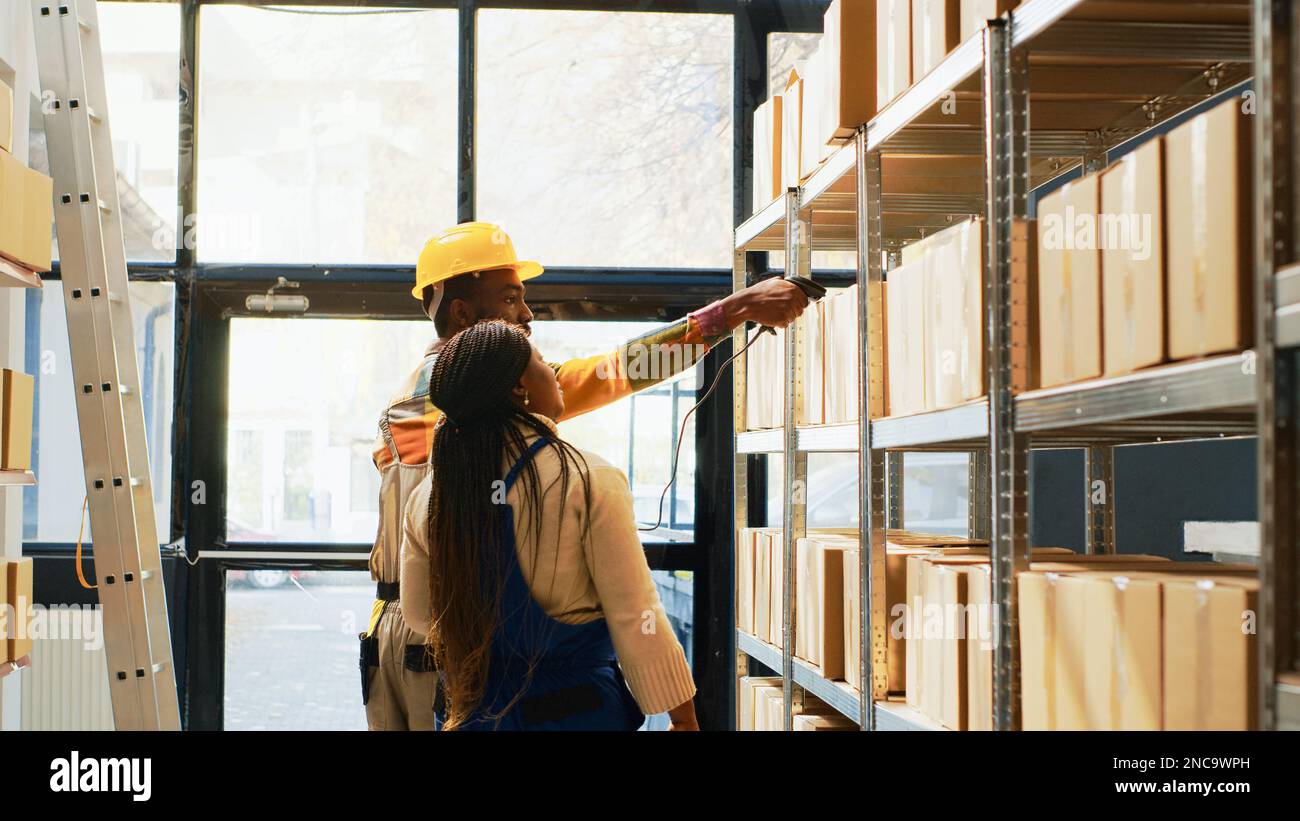 Team of warehouse employees working on inventory, scanning barcodes on ...