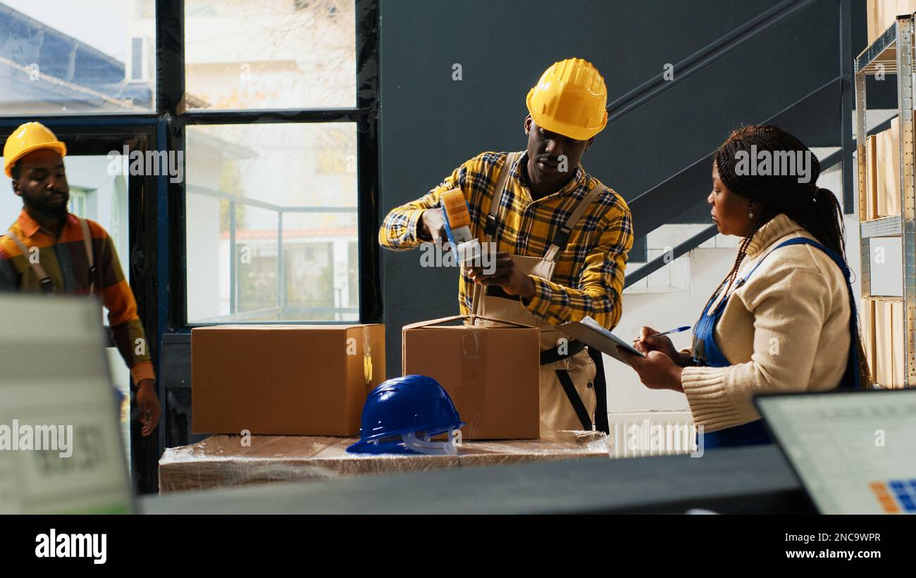 Production team working on logistics and quality control with stock ...