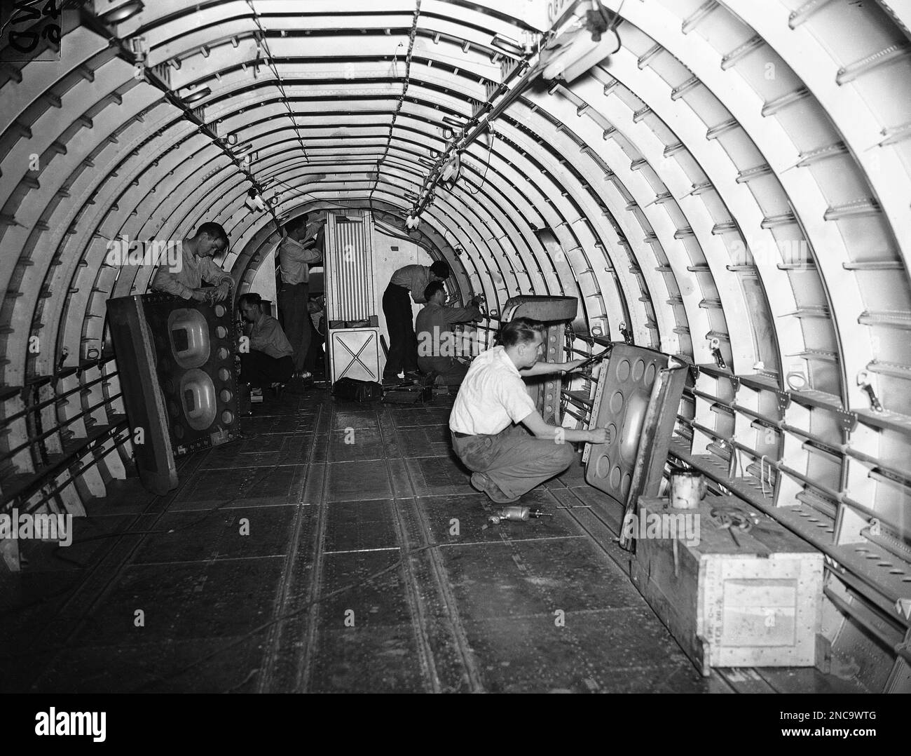 Mechanics work on the interior of the new Curtiss Commando (C46 ...