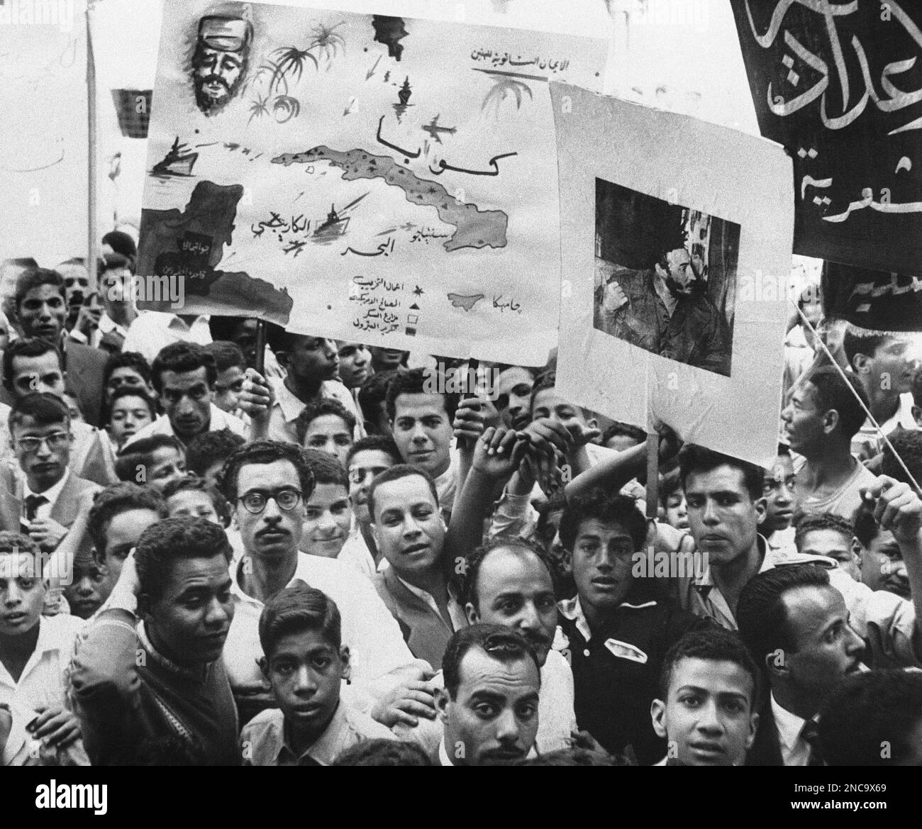 Pro-Castro demonstrators in Cairo on April 19, 1961 carry photo and ...