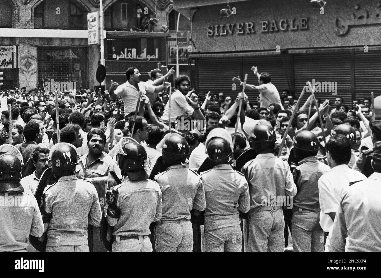 Riot police standing in front of pyramids of demonstrators as they are ...