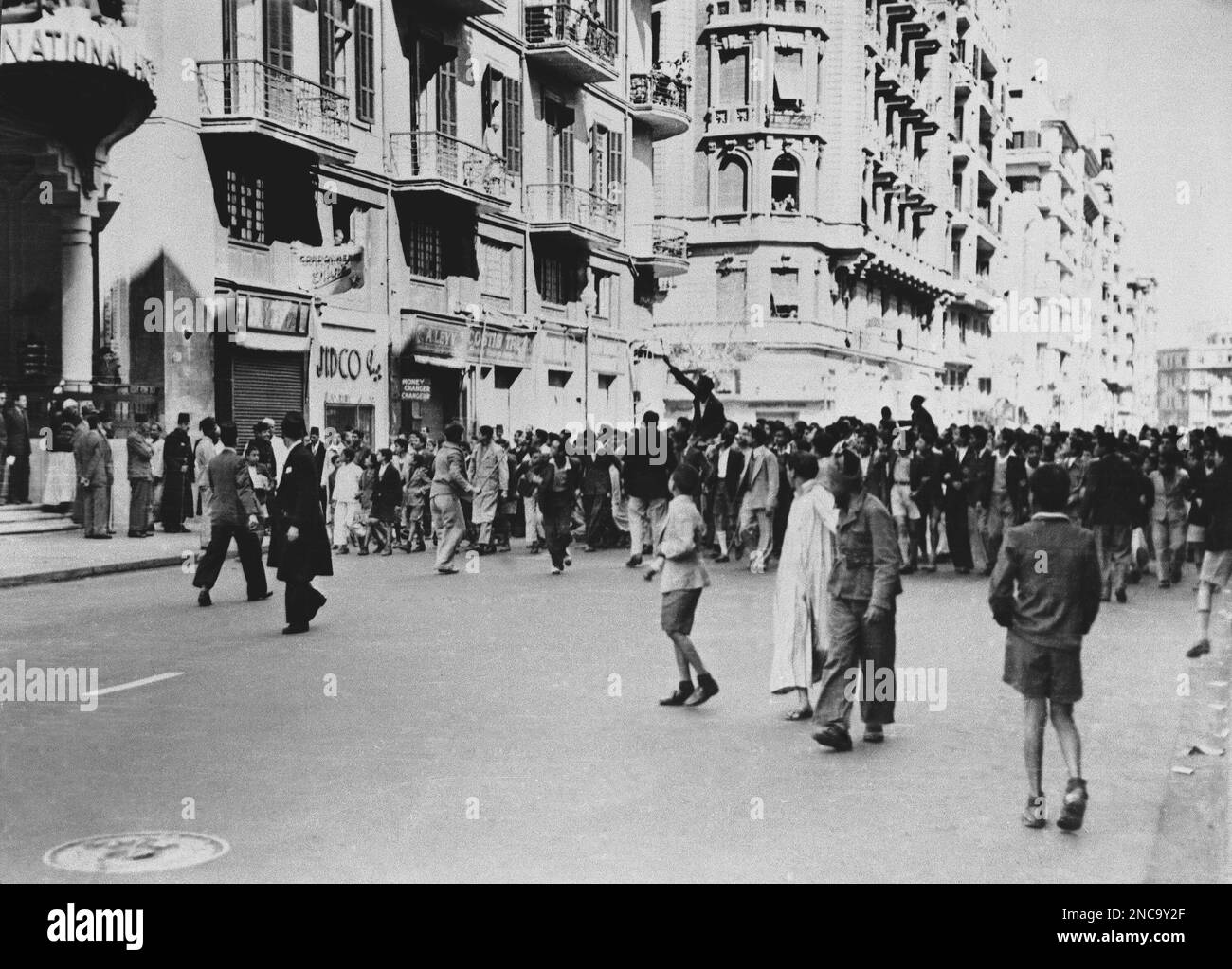 A crowd marches towards Shepherd Hotel in Cairo, Egypt on Jan. 25, 1952 ...