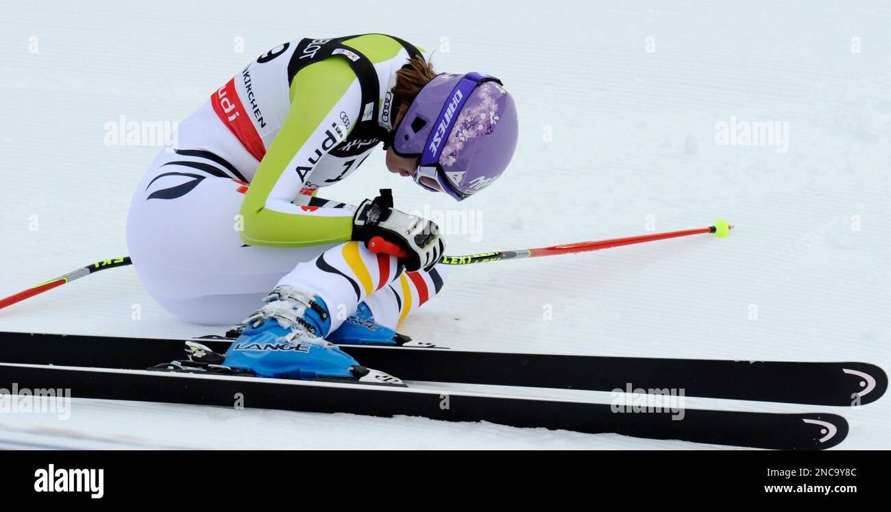 Germany's Maria Riesch lies exhausted after completing her run during ...