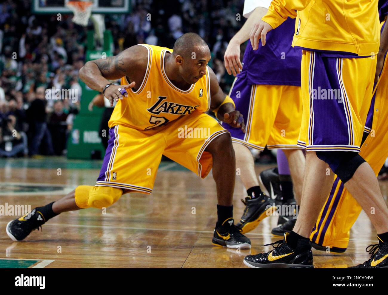 Los Angeles Lakers guard Kobe Bryant (24) bends low for a high-five ...
