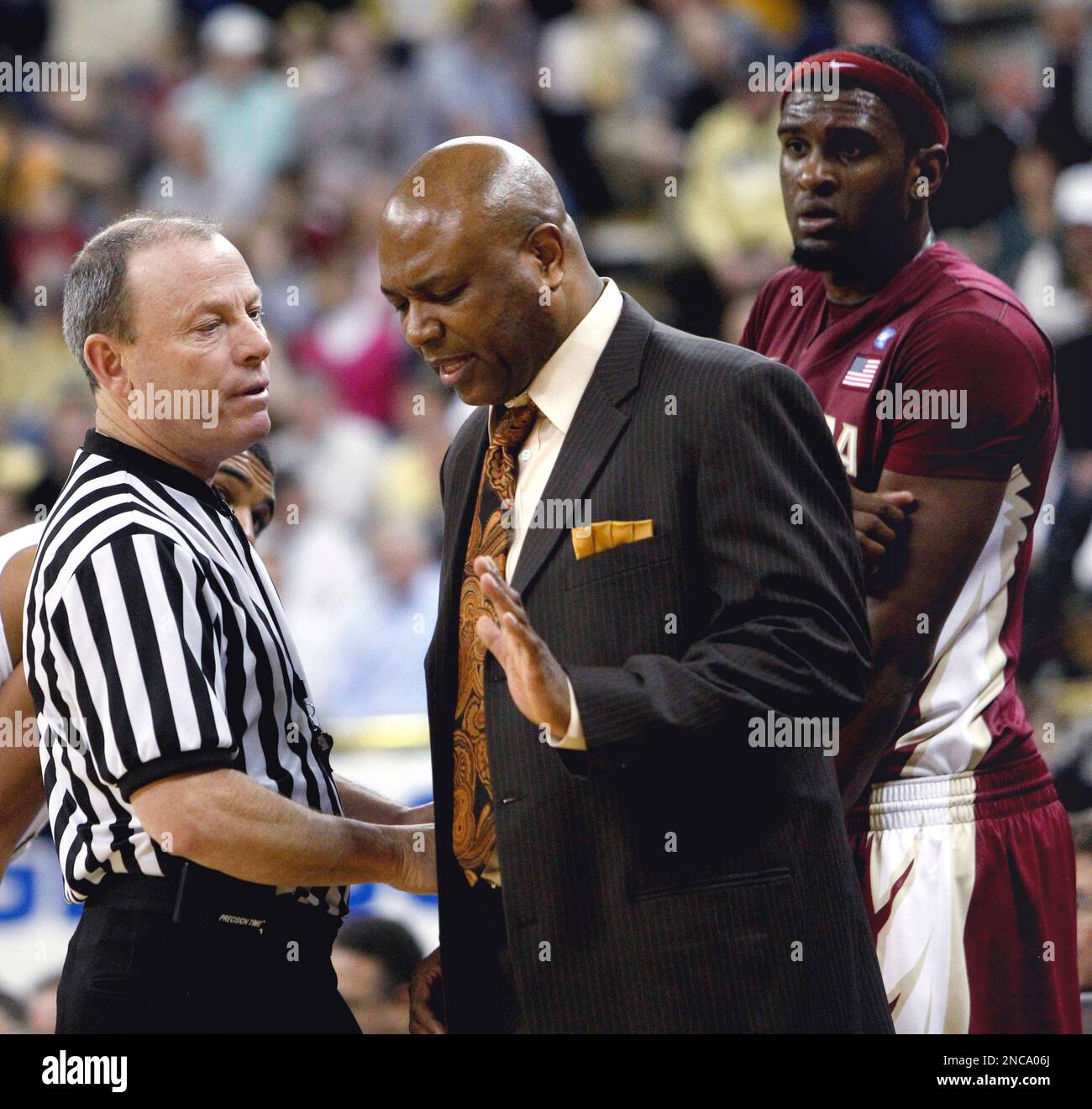 Florida State coach Leonard Hamilton, center, talks with official Ed ...