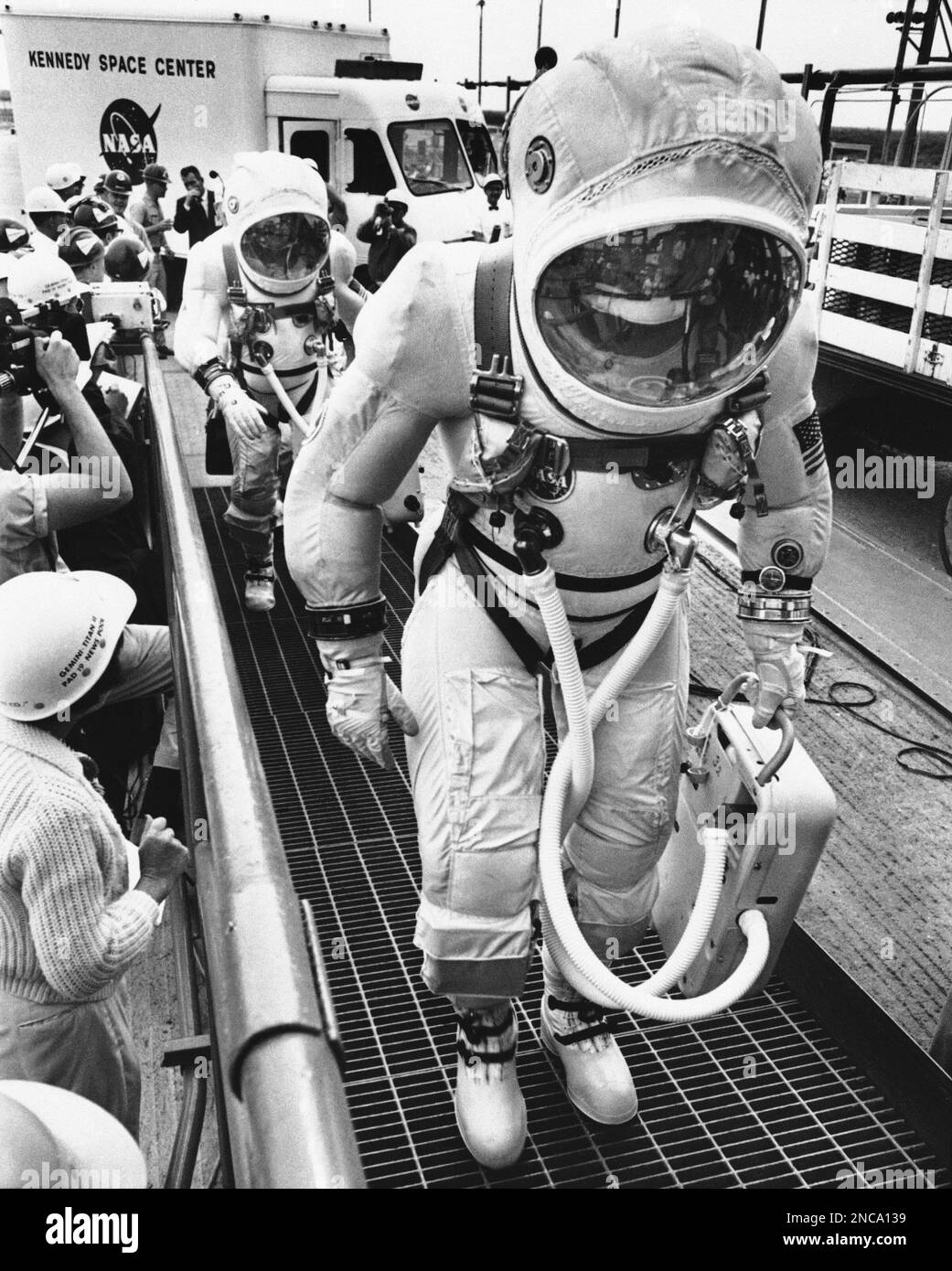 Command pilot Frank Borman, followed by his fellow Gemini 7 astronaut James Lovell carry their ...