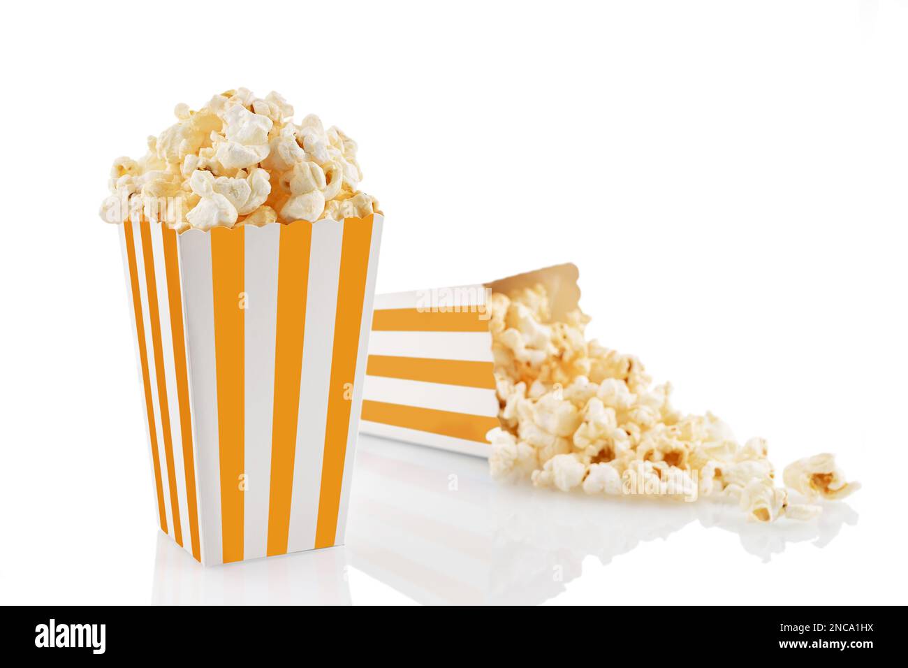 Two orange white striped carton buckets with tasty cheese popcorn ...