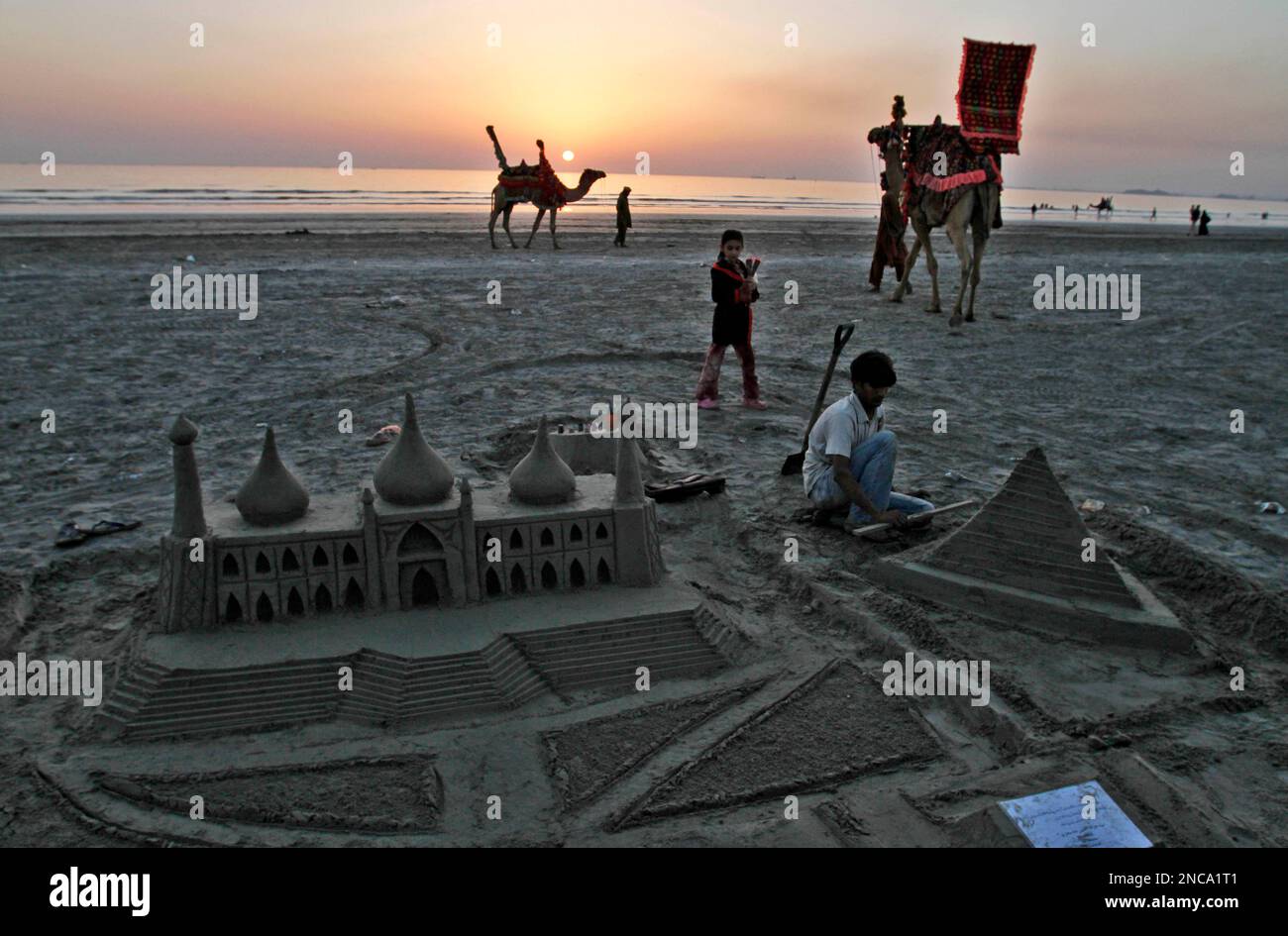 Pakistani sand artist Muhammad Arif gives finishing touches to sand ...