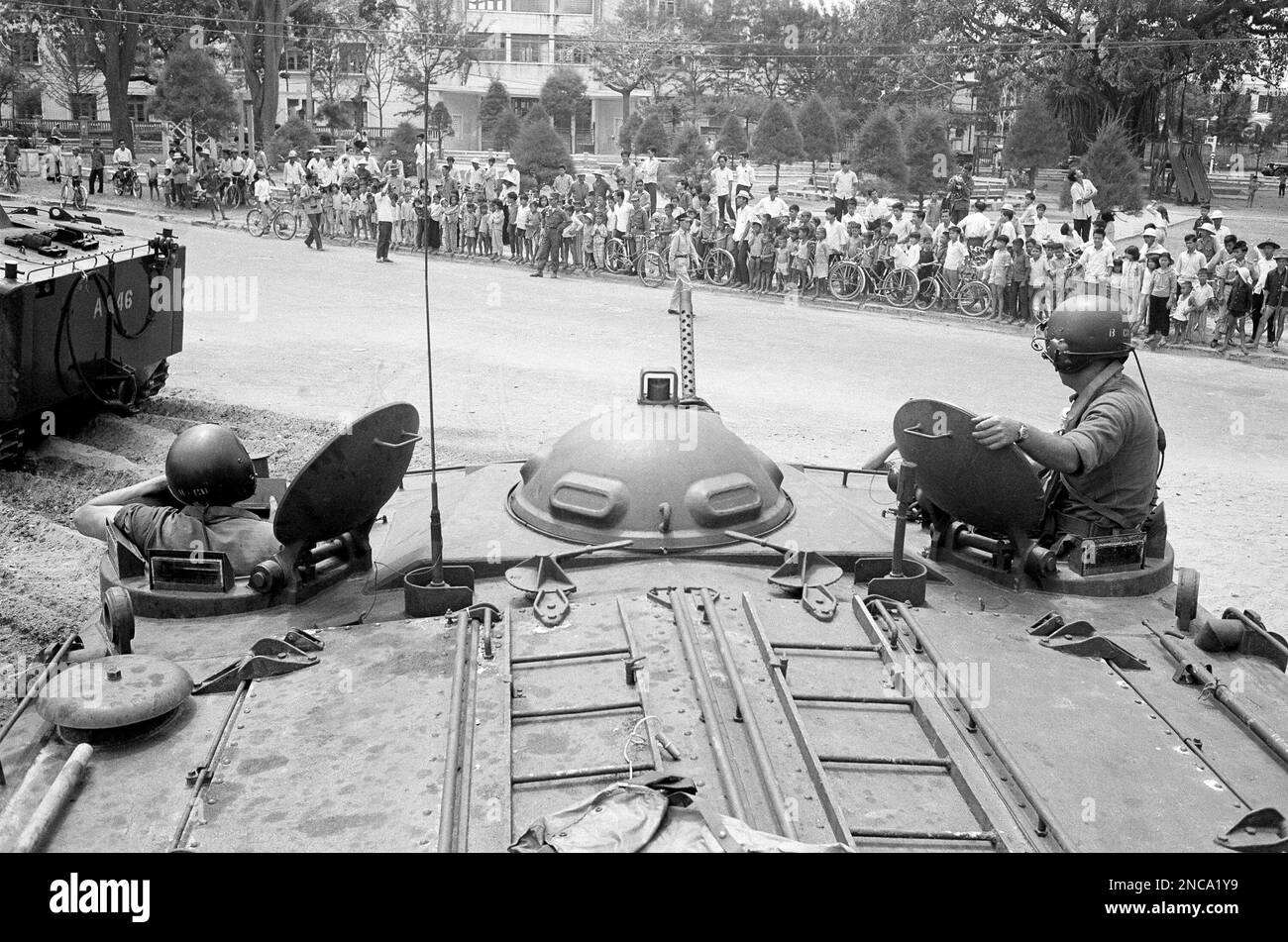 A crowd lines sidewalk in Da Nang, South Viet Nam on April 12, 1965, as ...