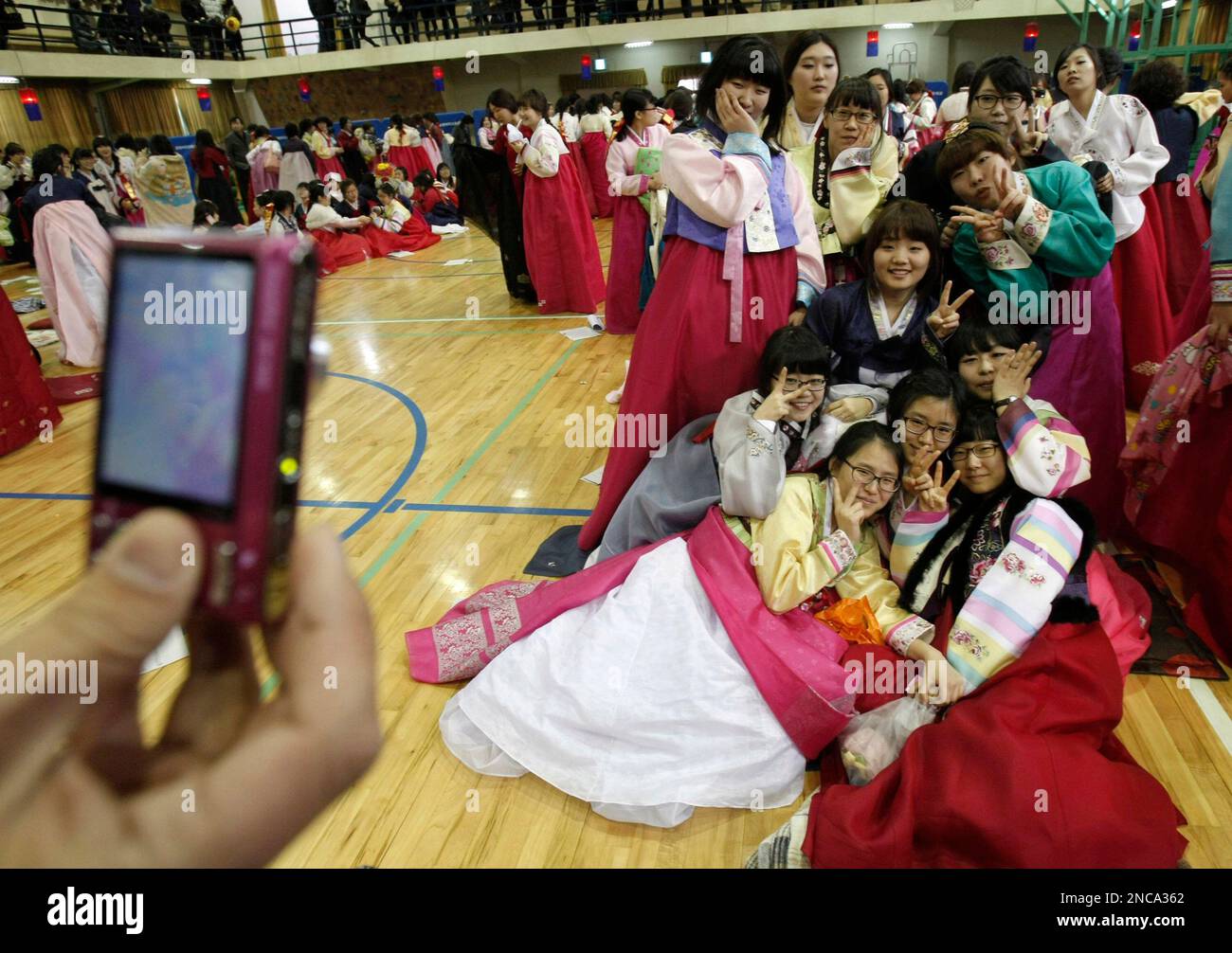 South Korean seniors clad in traditional attire pose for a souvenir ...