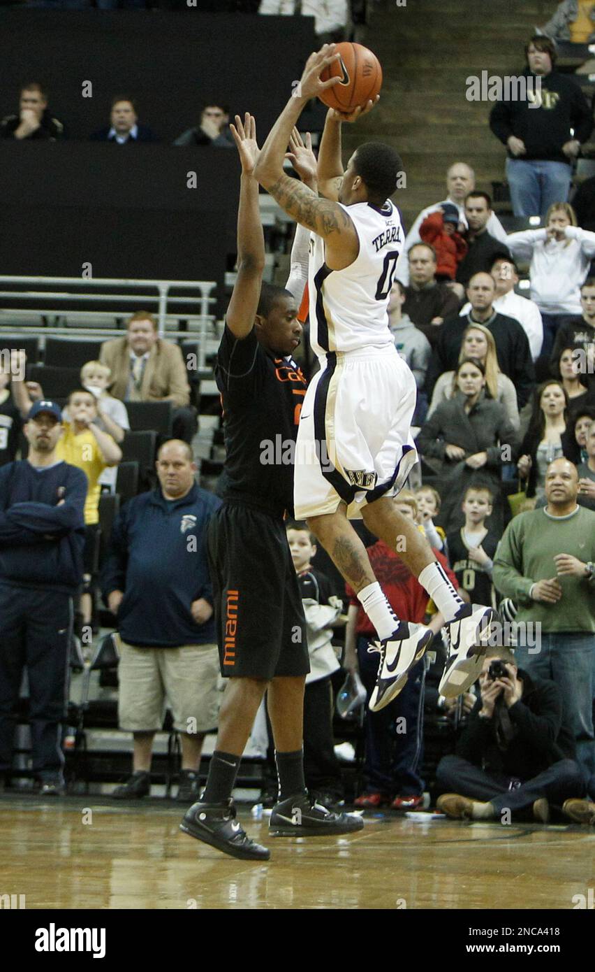 Wake Forest's J.T. Terrell, right, shoots over Miami's Garrius Adams ...