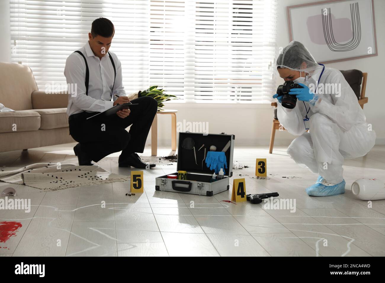 Investigators working at crime scene in living room Stock Photo - Alamy