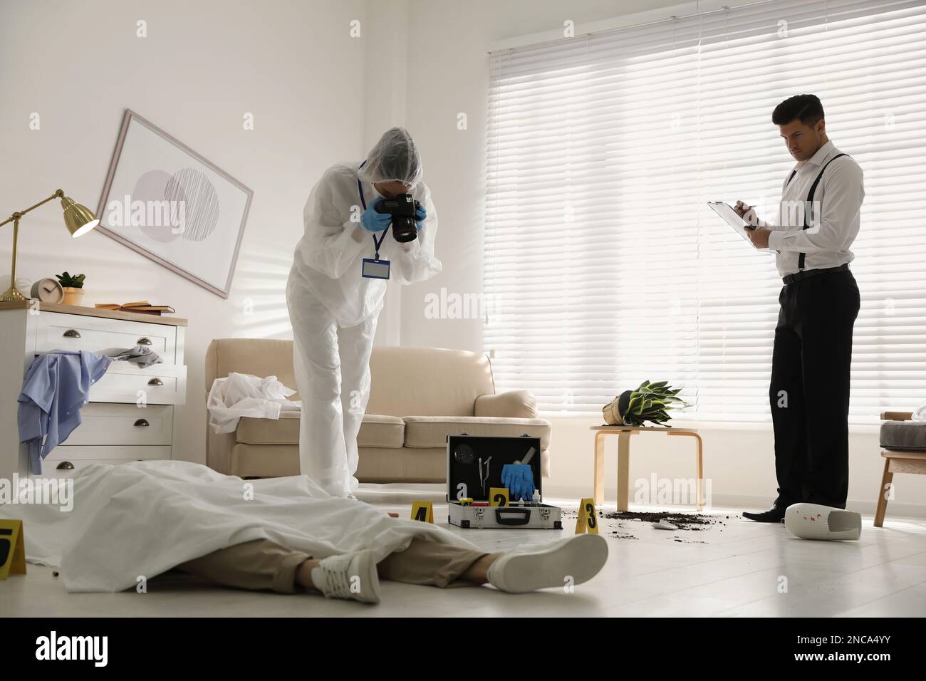 Investigators working at crime scene with dead body Stock Photo - Alamy