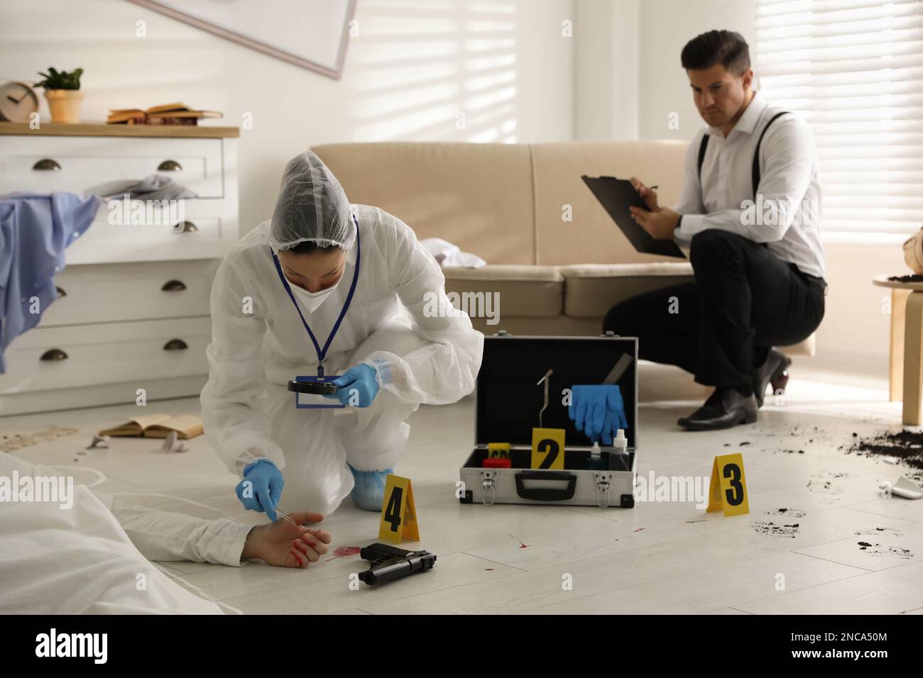 Investigators working at crime scene with dead body Stock Photo - Alamy