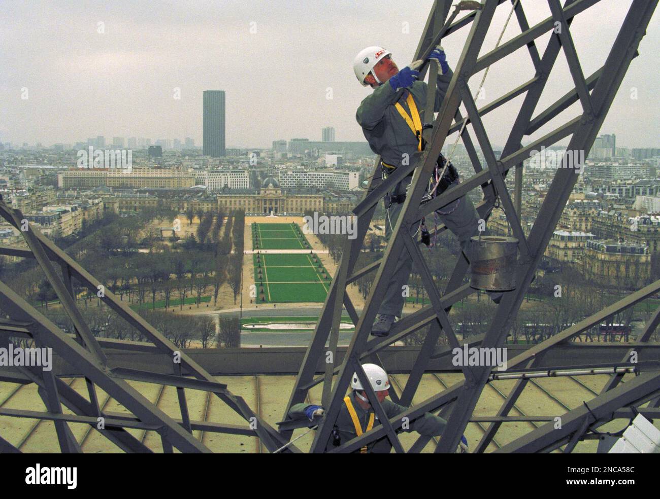 Equipped with alpine-style safety ropes and harnesses, one of a 25-man ...