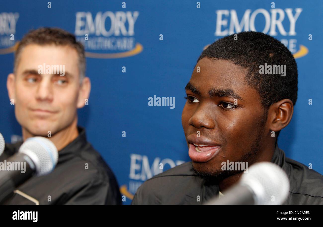 Wake Forest outfielder Kevin Jordan, right, speaks as his coach Tom ...