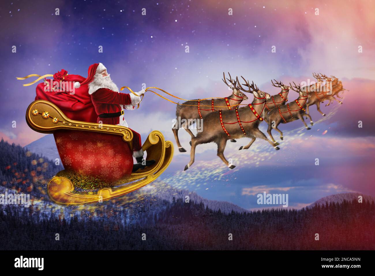 Magic Christmas eve. Santa with reindeers flying in sky Stock Photo - Alamy