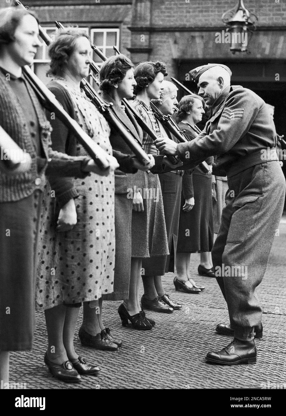 An army sergeant instructs these British women formed into an ...
