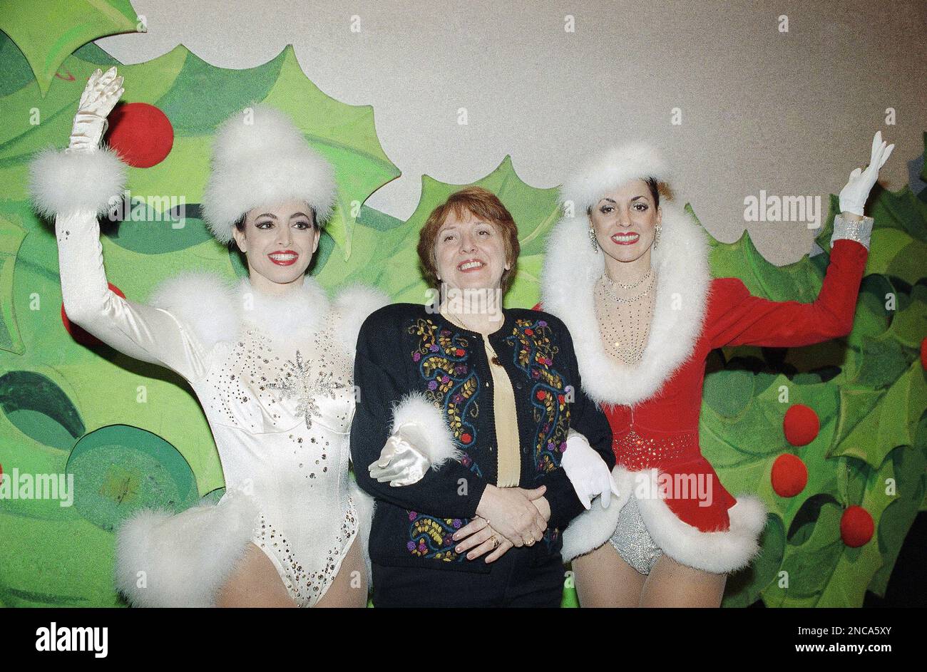 Violet Holmes is flanked by Rockettes Debby Kole, left, and Susanne ...