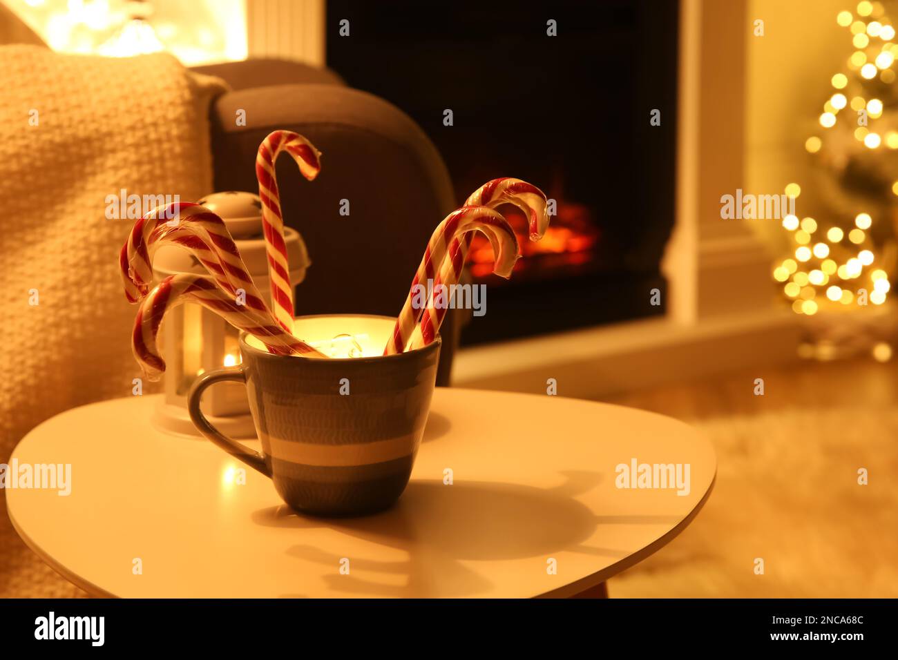 Christmas candy canes on table in room with fireplace Stock Photo - Alamy