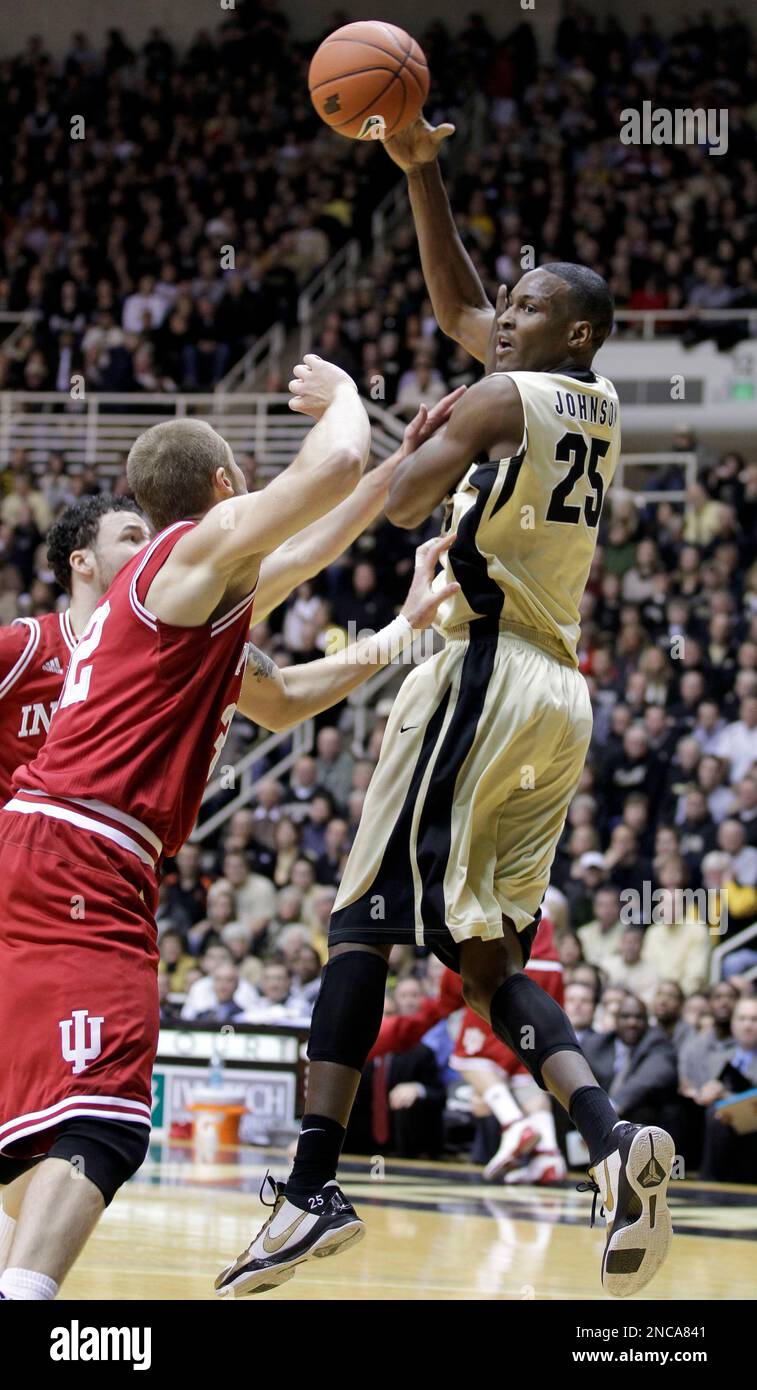Purdue center JaJuan Johnson, right, makes a pass over Indiana forward ...