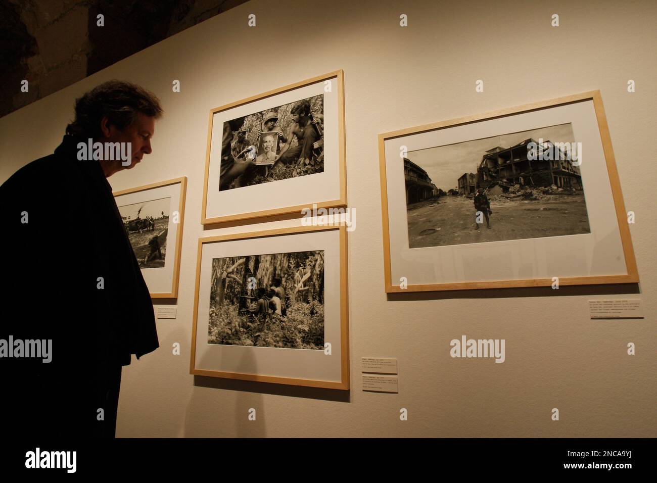 A man looks at the photos of the the 'Henri Huet, Vietnam' exhibition ...