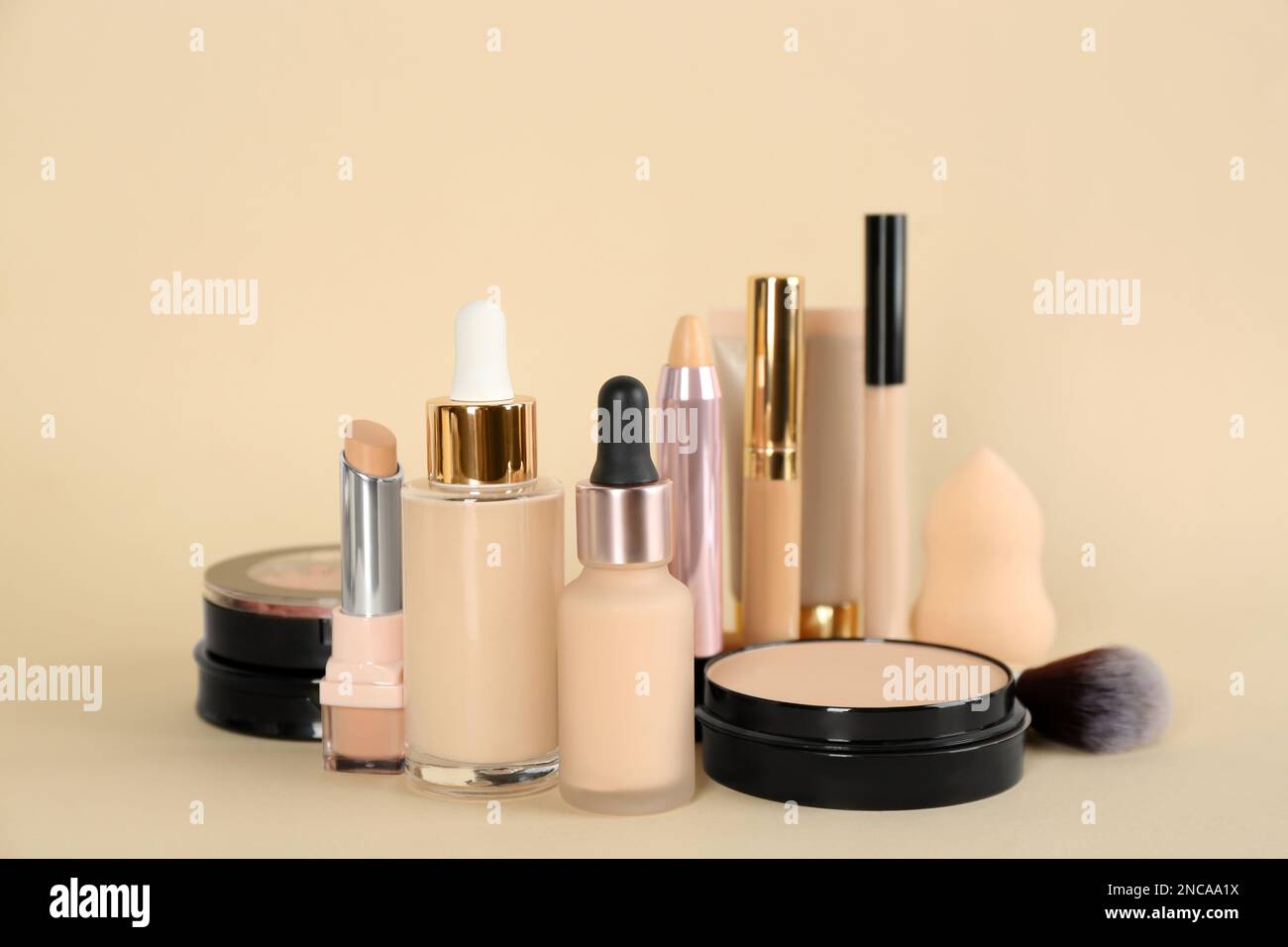Foundation makeup products on beige background. Decorative cosmetics ...