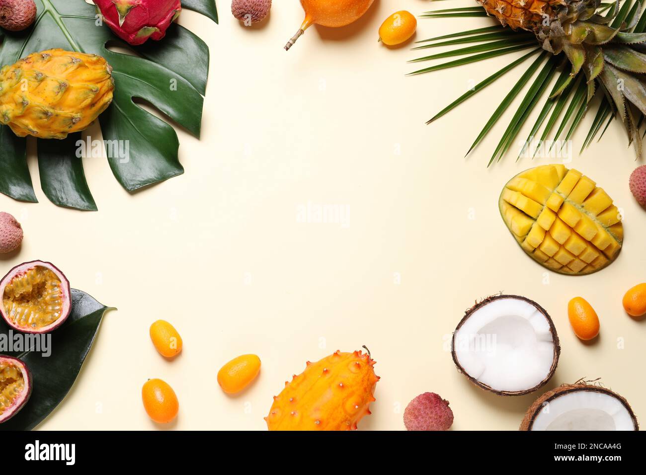 Frame of different exotic fruits on beige background, flat lay. Space ...