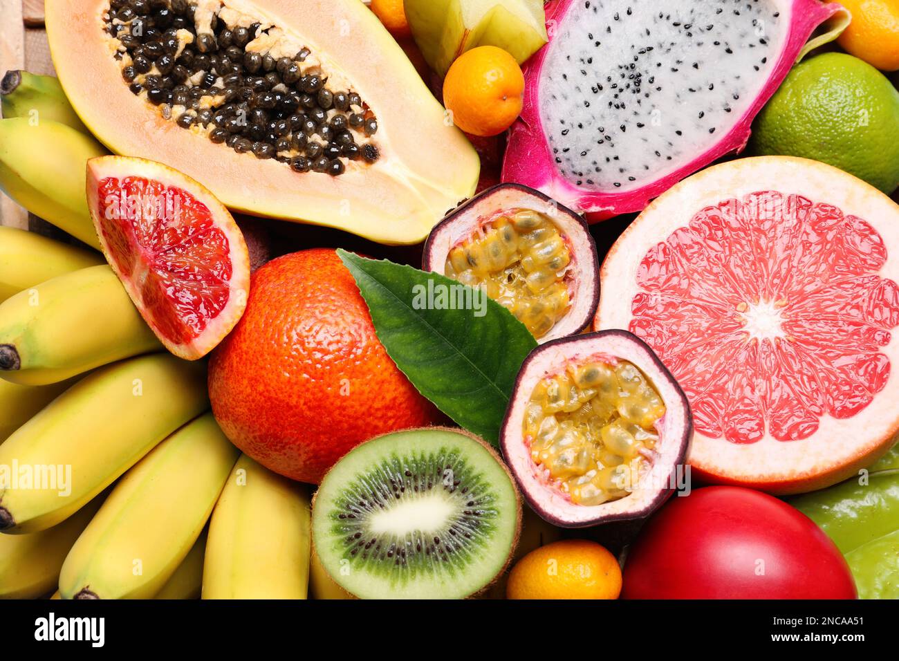 Different delicious exotic fruits as background, top view Stock Photo ...