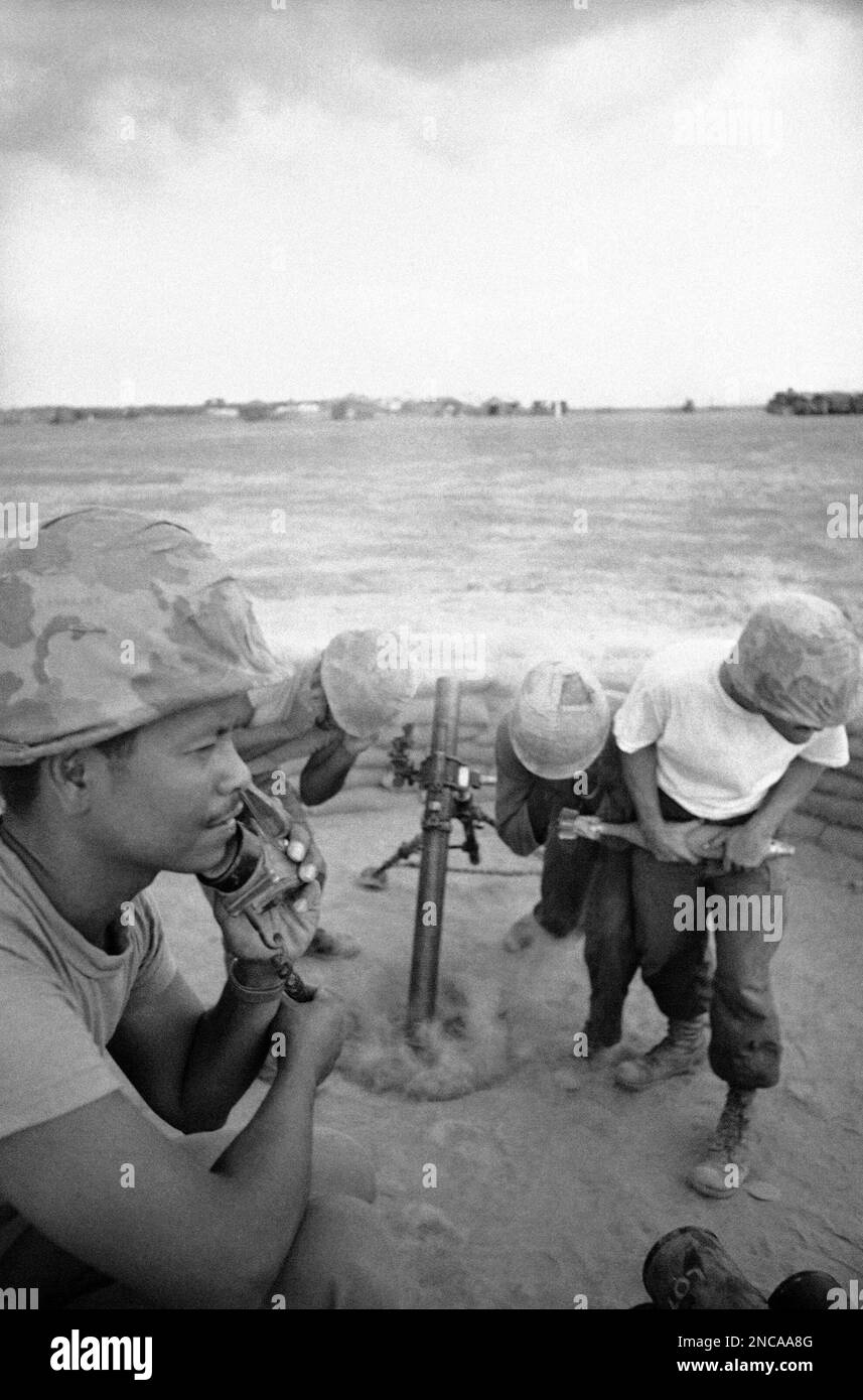 A mortar crew of the U.S. 25th infantry division fires a fast series of ...