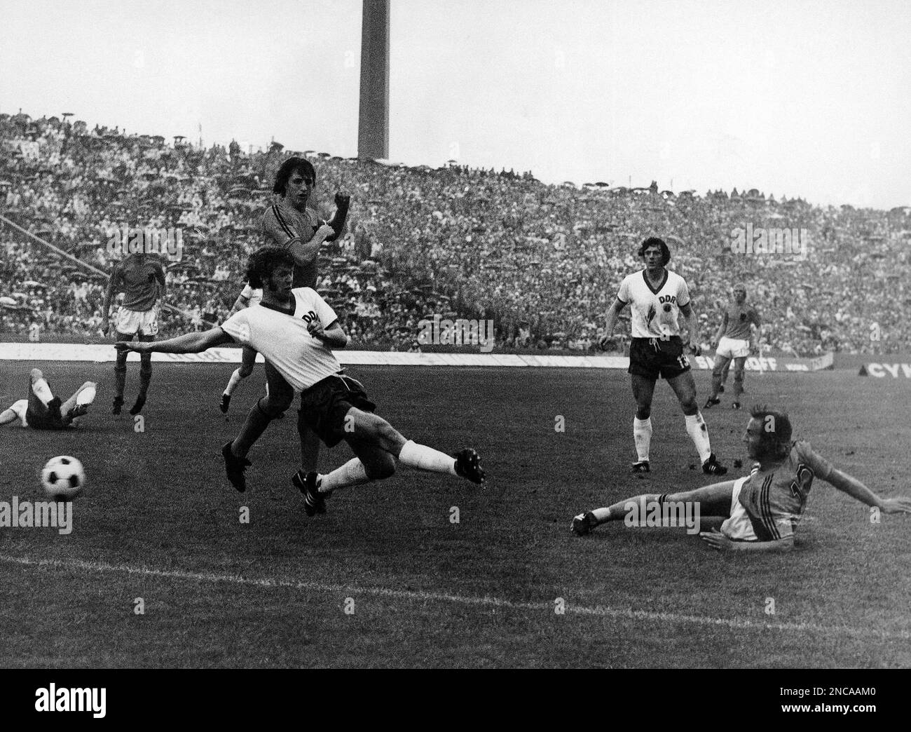 Johan Neeskens of The Netherlands (right on ground) scores the first ...