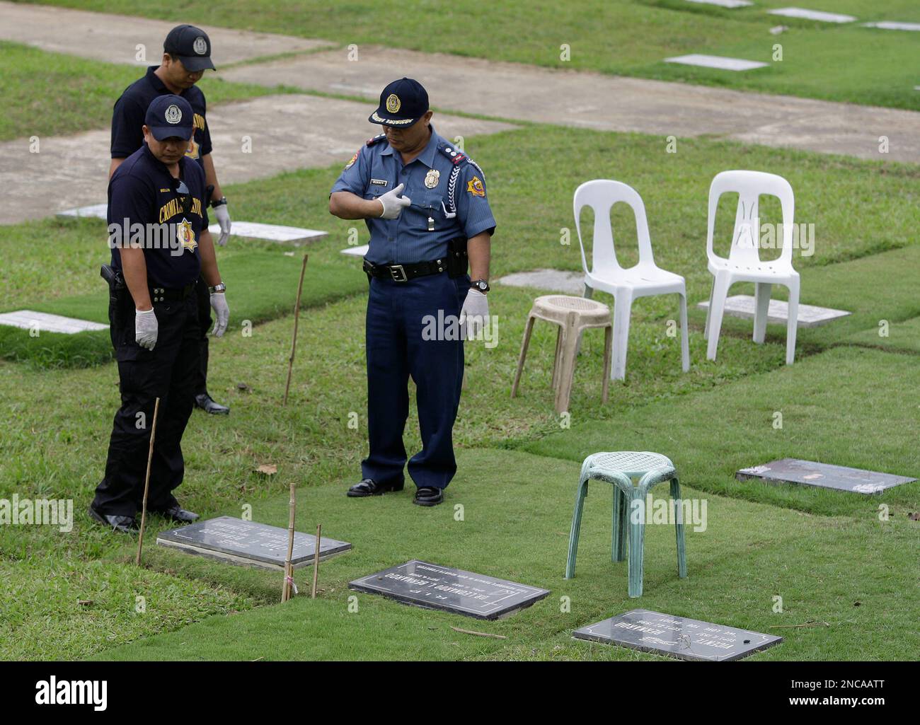 A police investigator gestures as they check an area where retired Gen ...