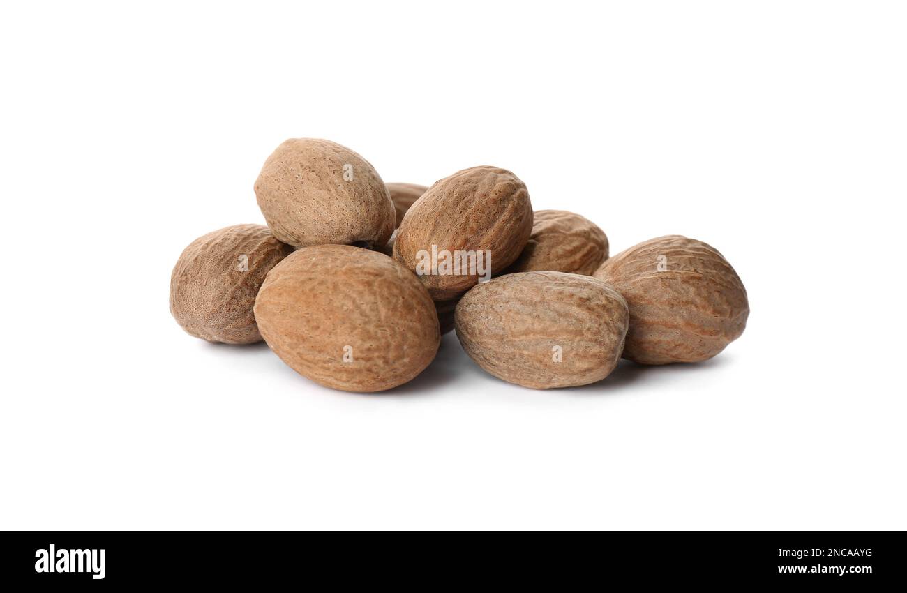 Heap of nutmeg seeds on white background Stock Photo - Alamy