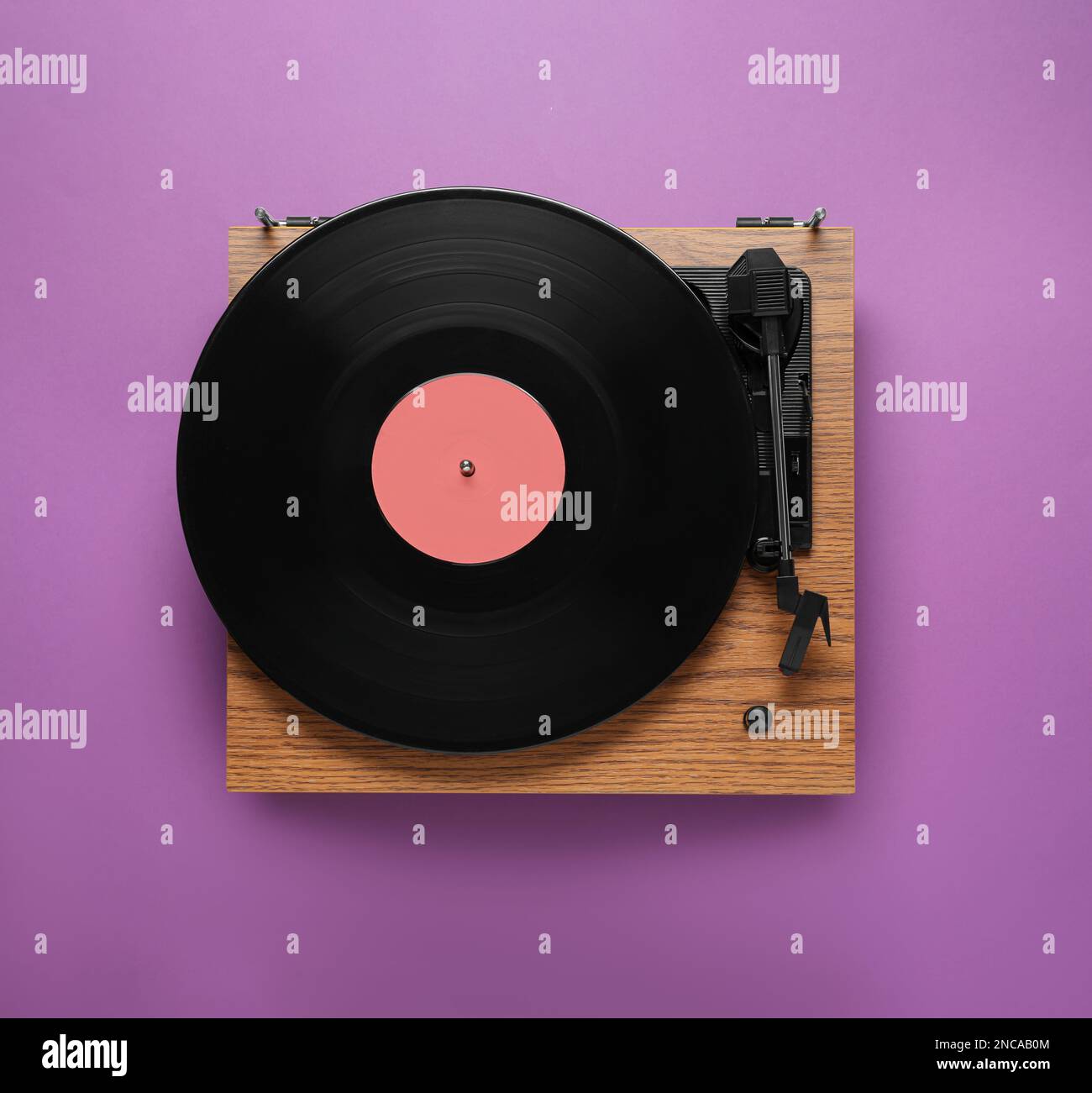 Modern turntable with vinyl record on purple background, top view Stock ...