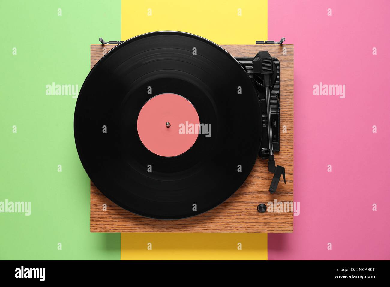 Modern turntable with vinyl record on color background, top view Stock ...