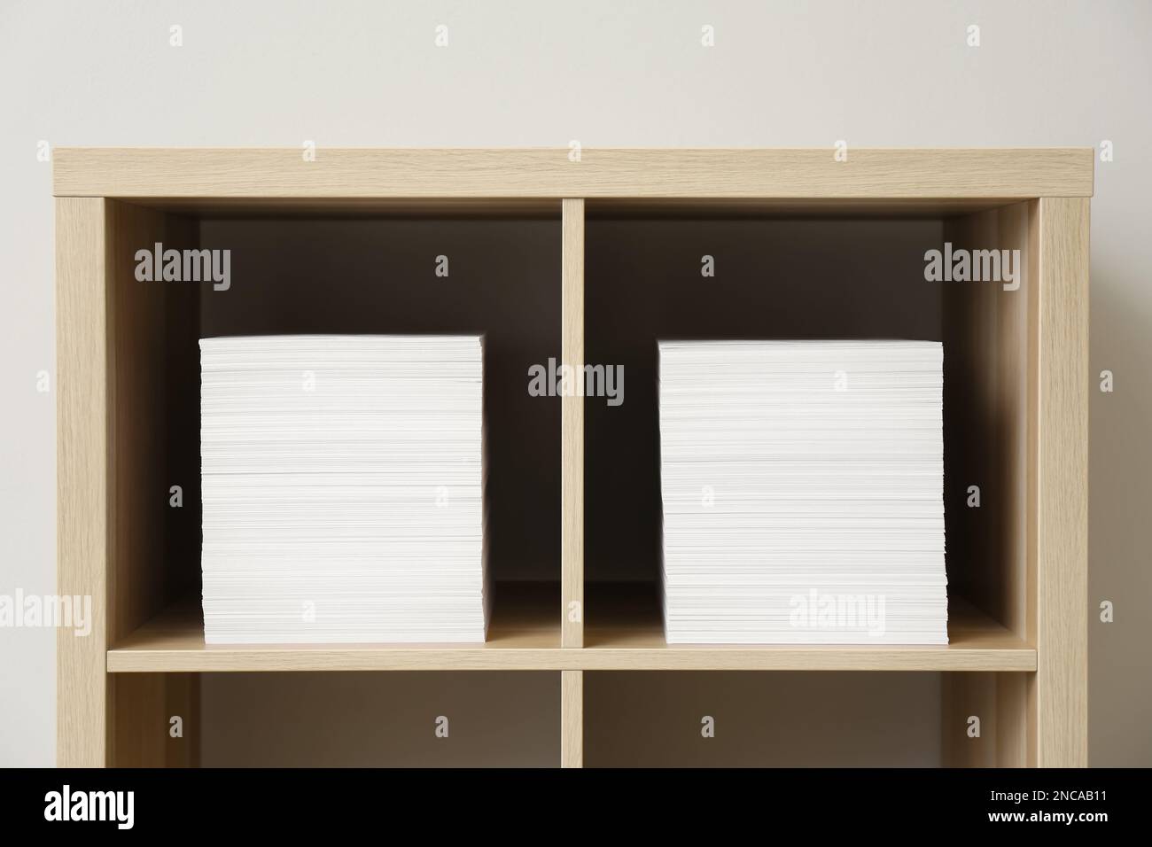 Stacks of paper sheets on shelves indoors Stock Photo - Alamy