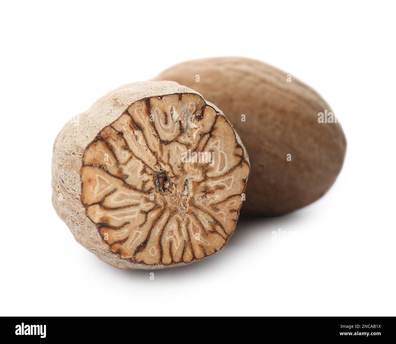 Whole and cut nutmeg seeds isolated on white Stock Photo - Alamy