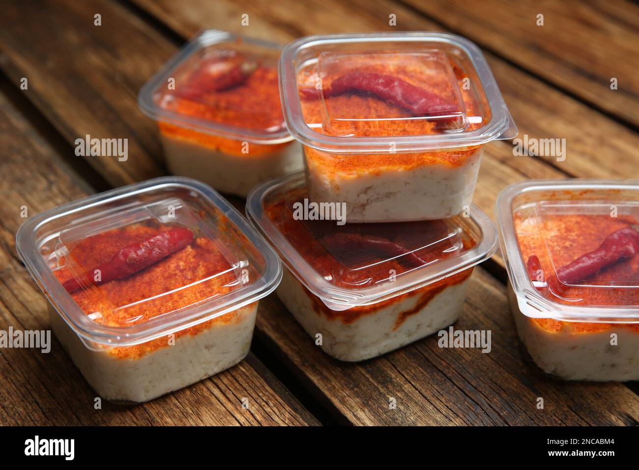 Savoury spread with lard in plastic containers on wooden table. Food ...
