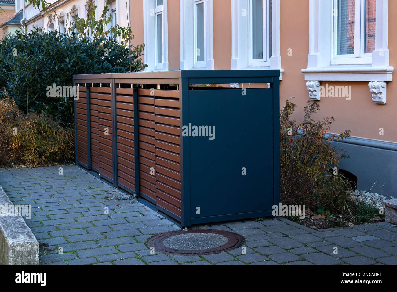 Stylish brown container for trash bins and garbage bins near ...