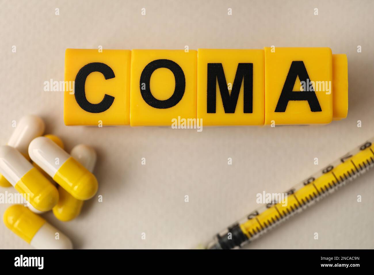Word Coma of cubes, syringe and pills on beige background, flat lay ...