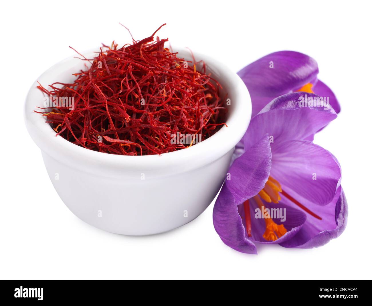 Dried saffron in bowl and crocus flowers on white background Stock ...