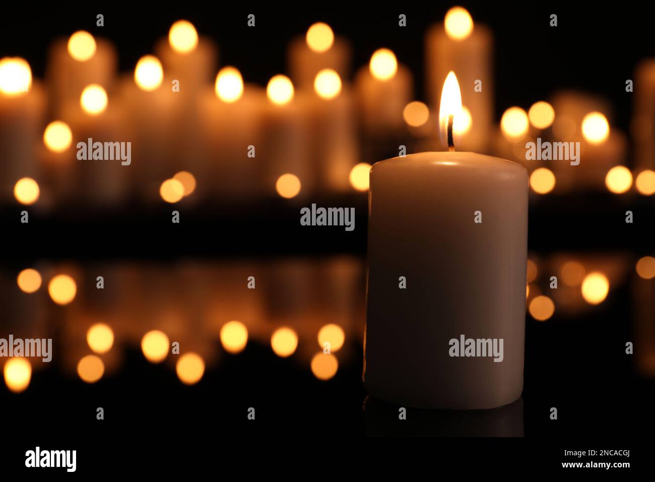 Burning candle in darkness, space for text. Memory day Stock Photo - Alamy