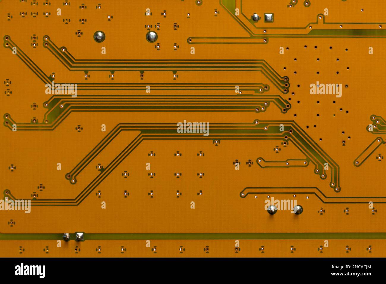 The reverse side of the electronic circuit board is yellow-brown. Close ...