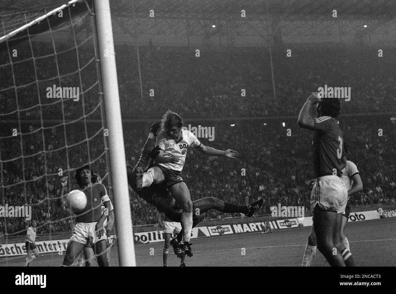 East Germany’s Martin Hoffmann, scores his team’s goal from mid-air ...